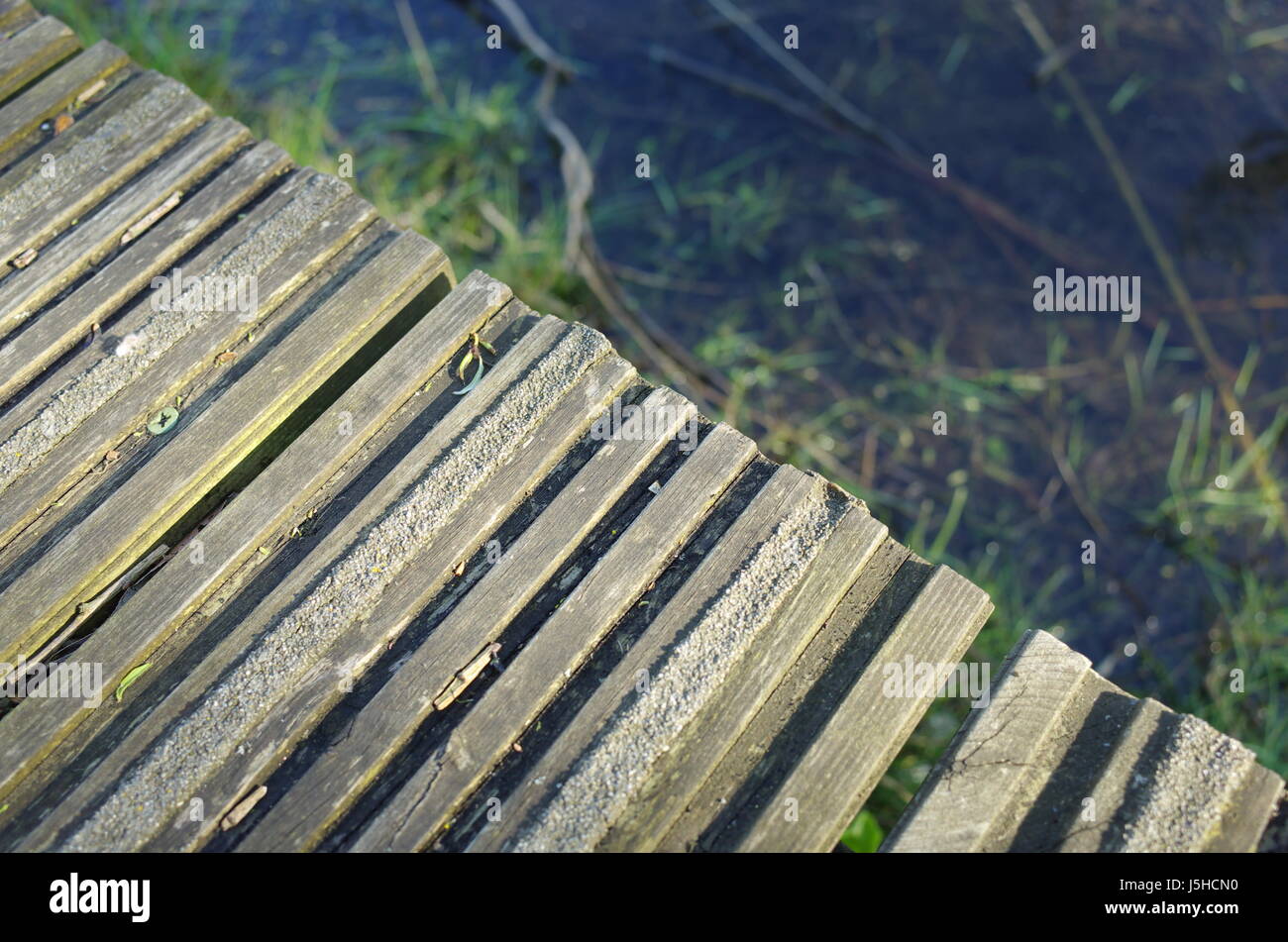 edge of boardwalk over water Stock Photo - Alamy