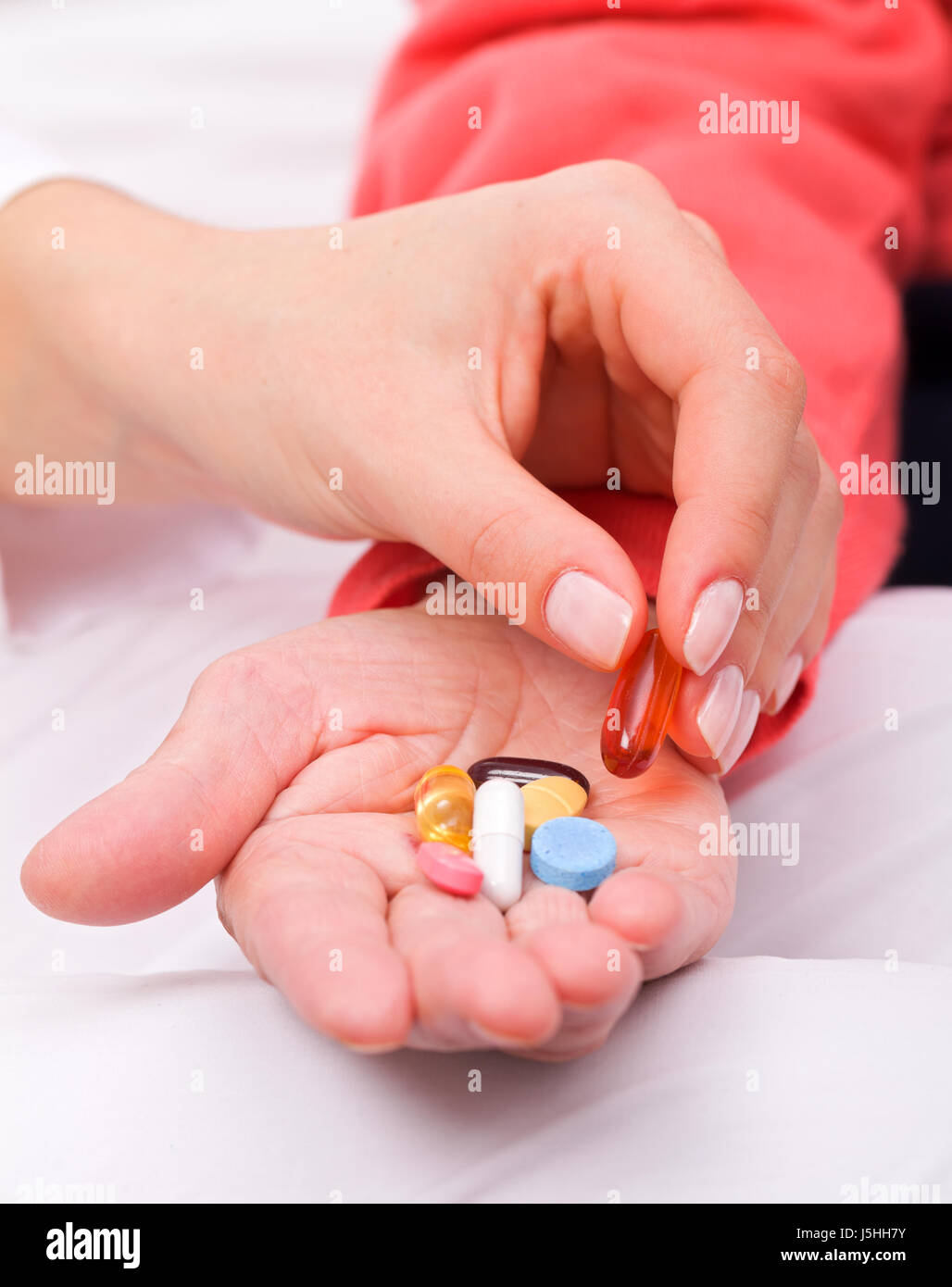 Caregiver giving medication to her senior patient Stock Photo - Alamy