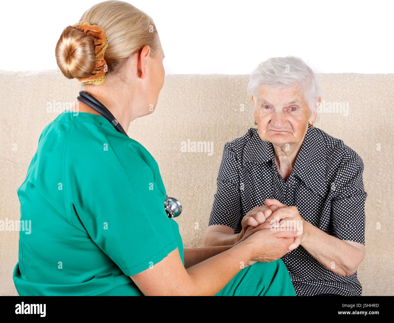 Female doctor helping a sick senior lady Stock Photo - Alamy