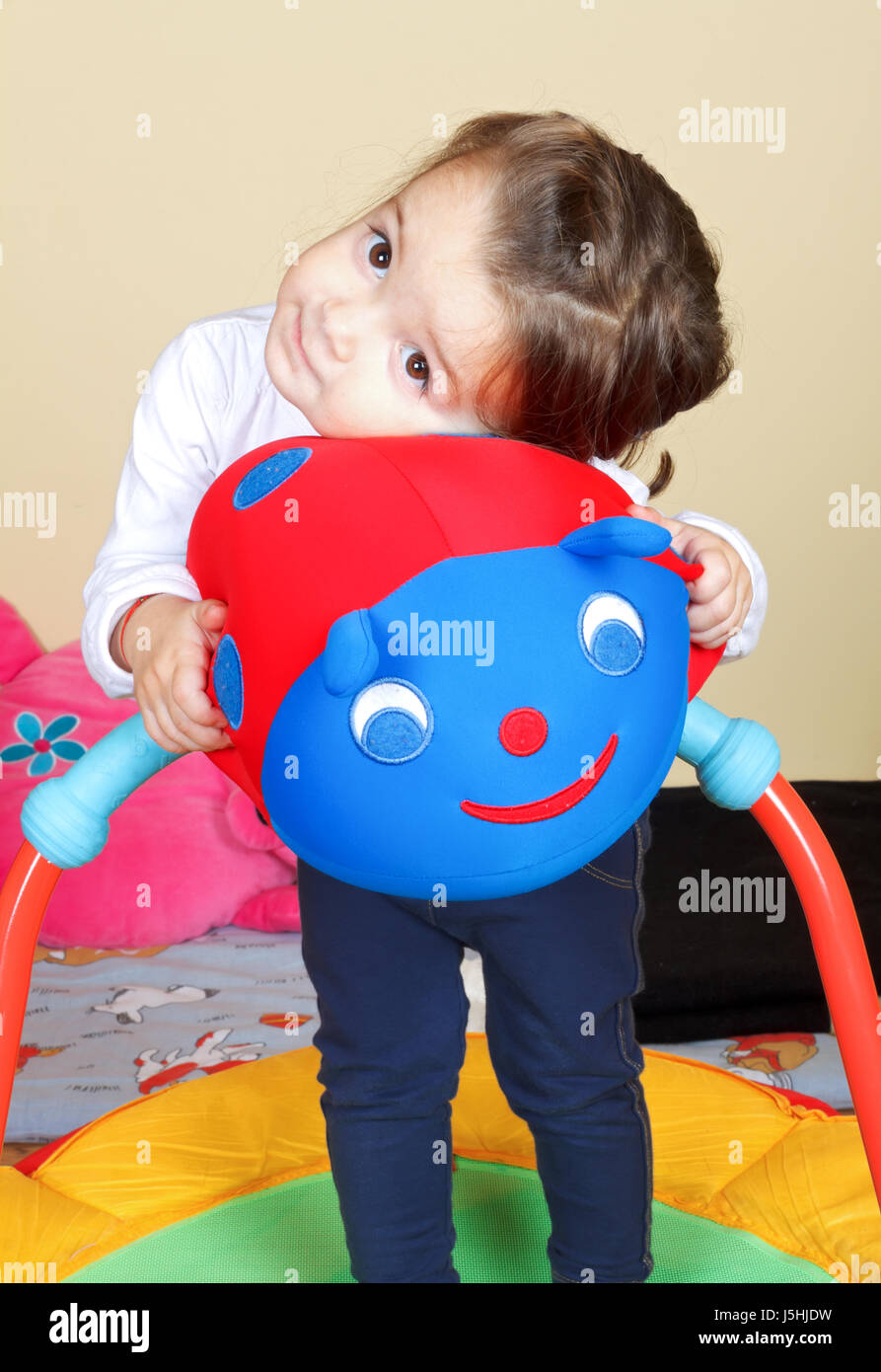 Picture of a little girl hugging her toy Stock Photo - Alamy