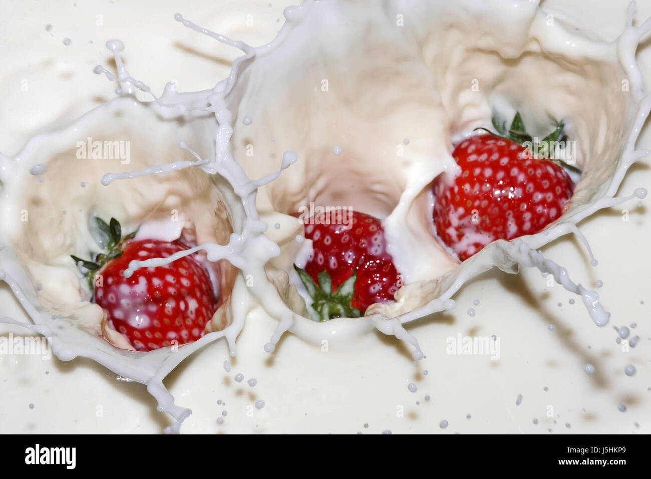 strawberries falling into milk Stock Photo - Alamy