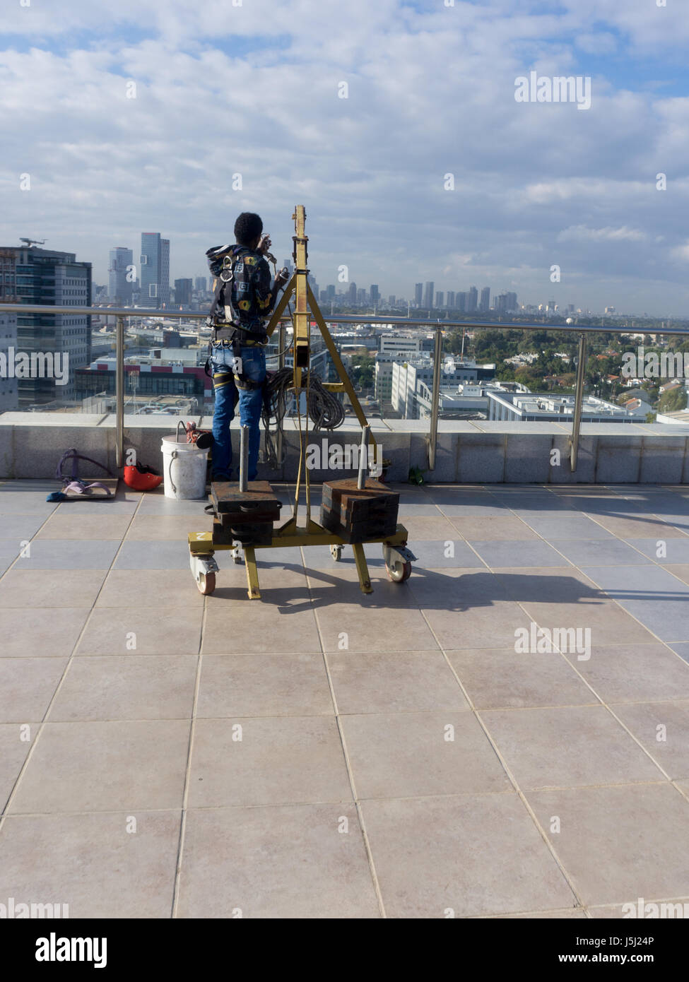 Window cleaning employee with work tools and city background Stock ...