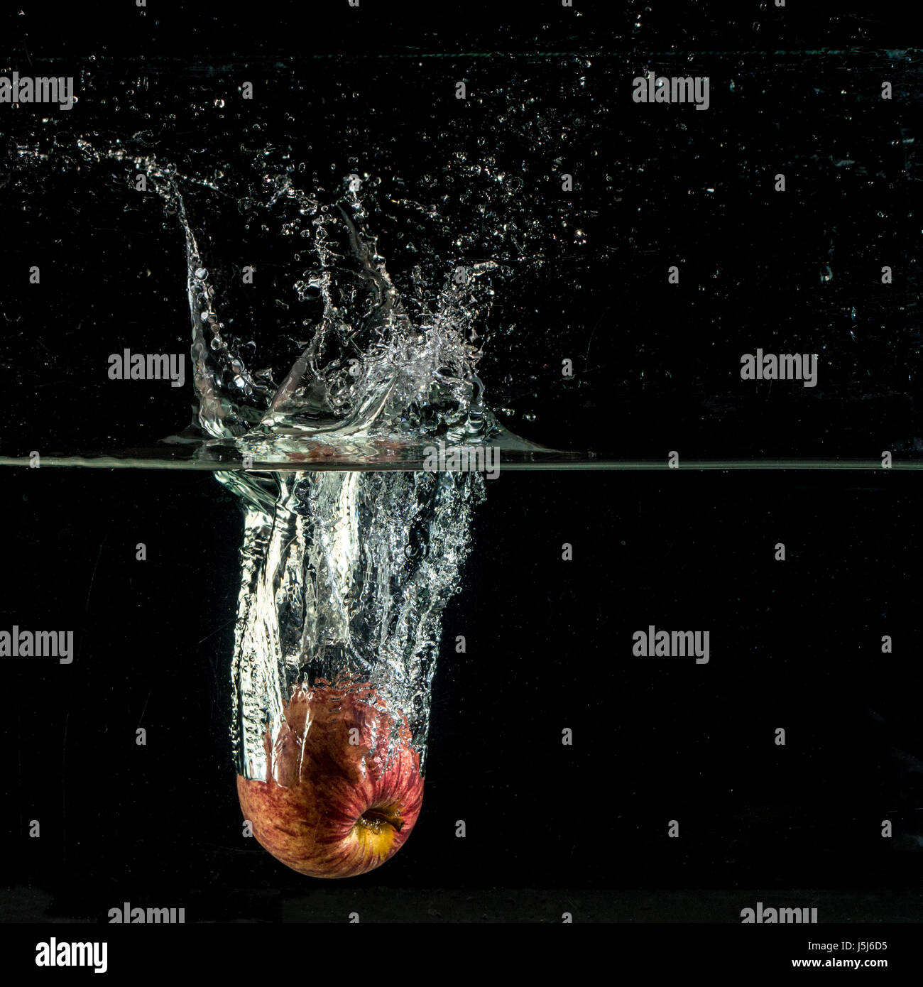 Fruit splashing into water Stock Photo - Alamy