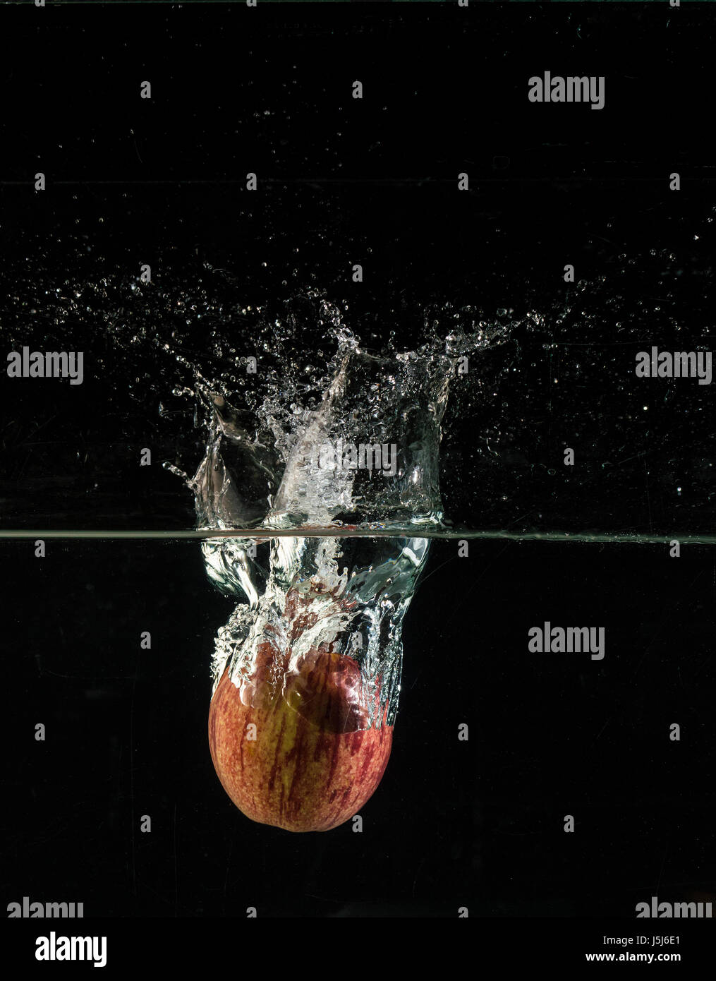 Fruit splashing into water Stock Photo - Alamy