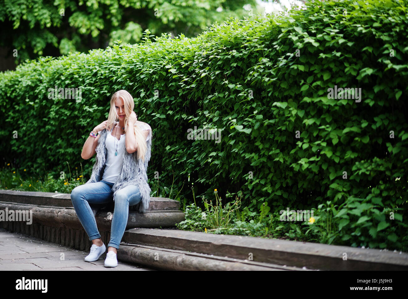 Stylish Blonde Woman Wear At Jeans And Girl Sleeveless With White Shirt
