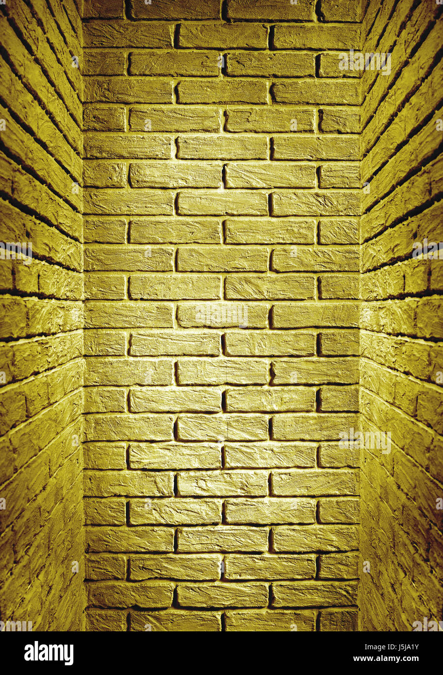 yellow toned brick wall end of the corridor, abstract background photo ...