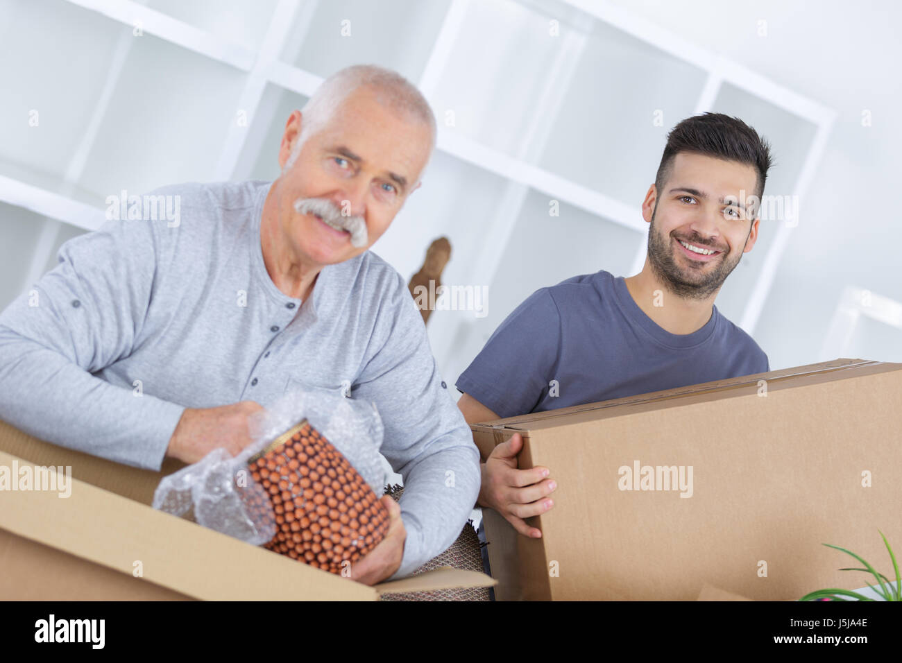 posing and smiling while packing Stock Photo - Alamy