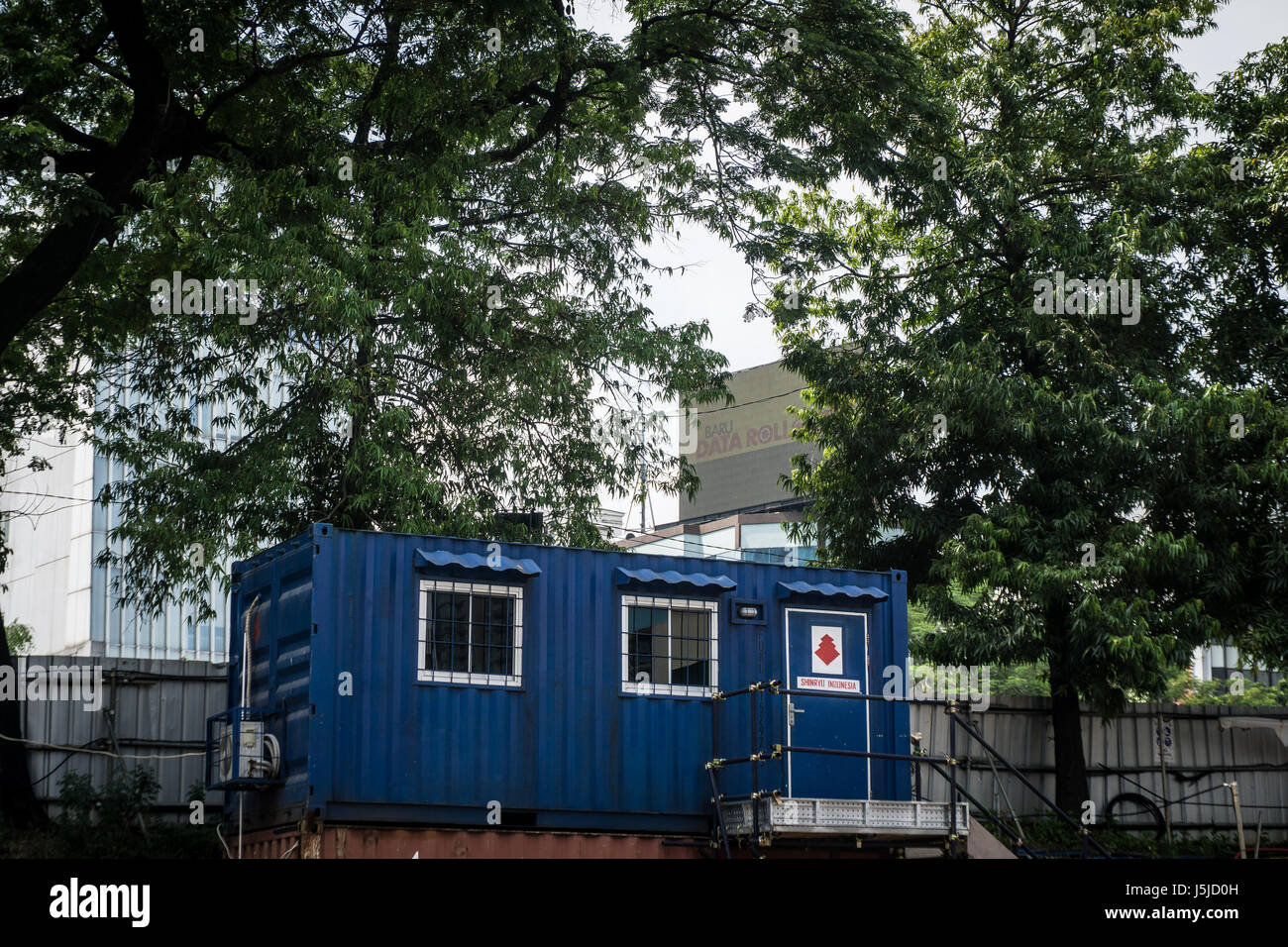 blue container house as office or house with green tree as background ...