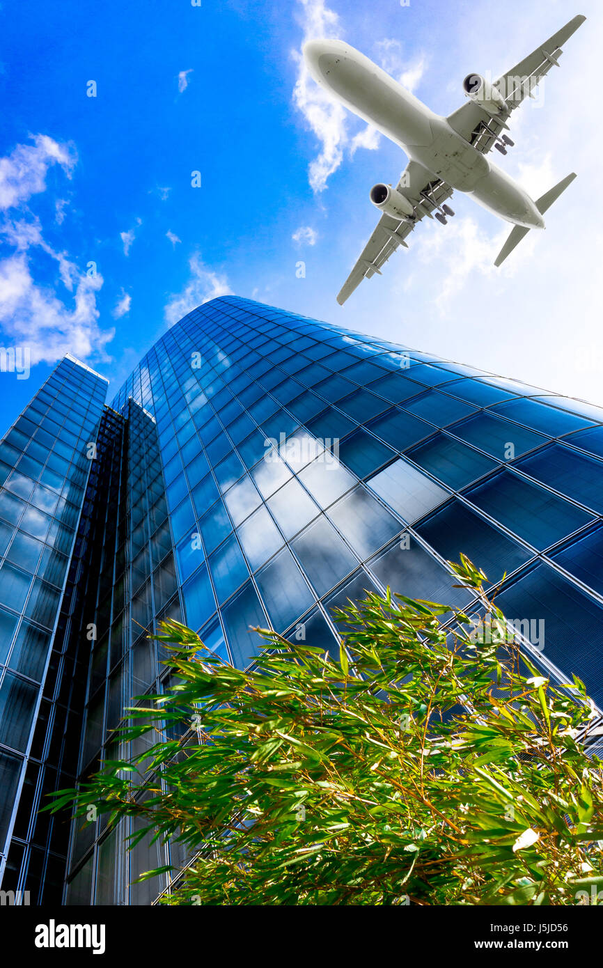 aeroplane flying over the skyscrapers. architecture building with ...