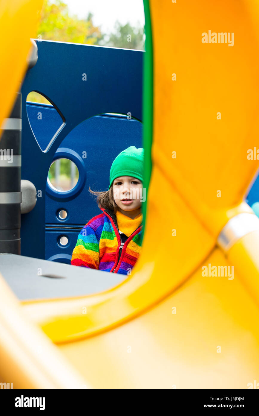 Child boy sitting in playground outside Stock Photo - Alamy