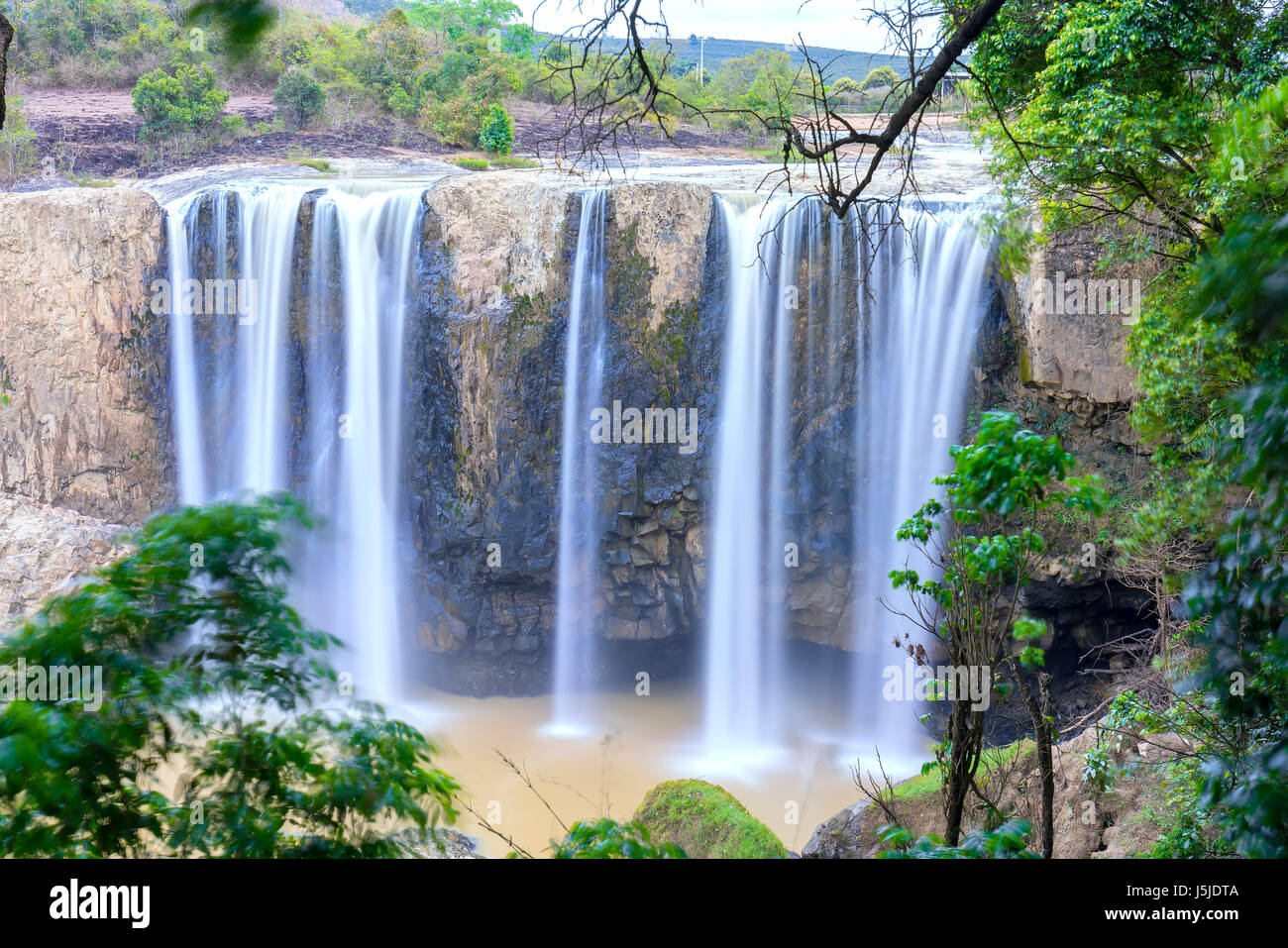 Natural waterfalls in the wild forest with high water flow down to the ...