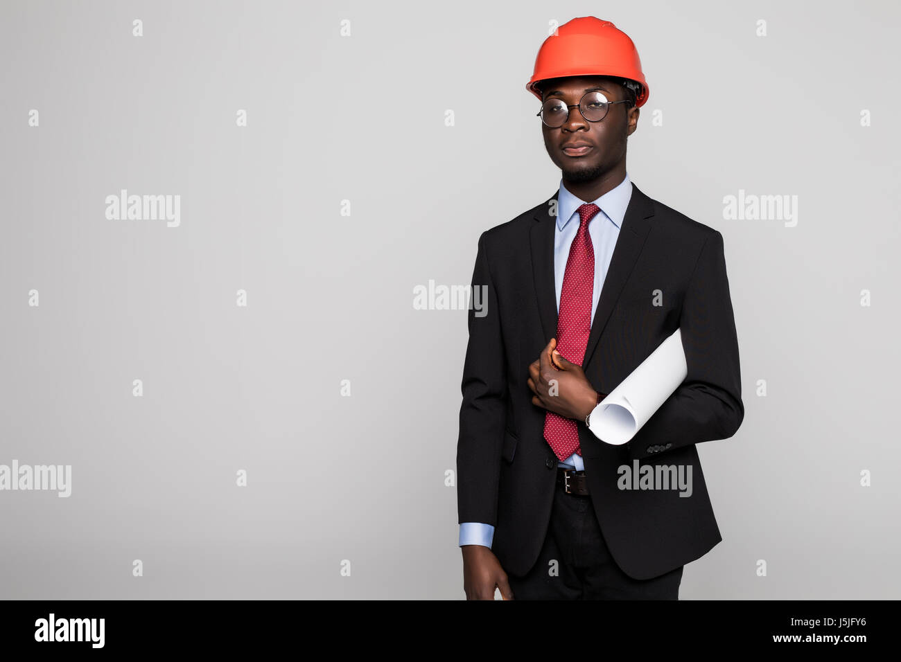 Young Afro-American engineer with blueprints isolated on white Stock ...