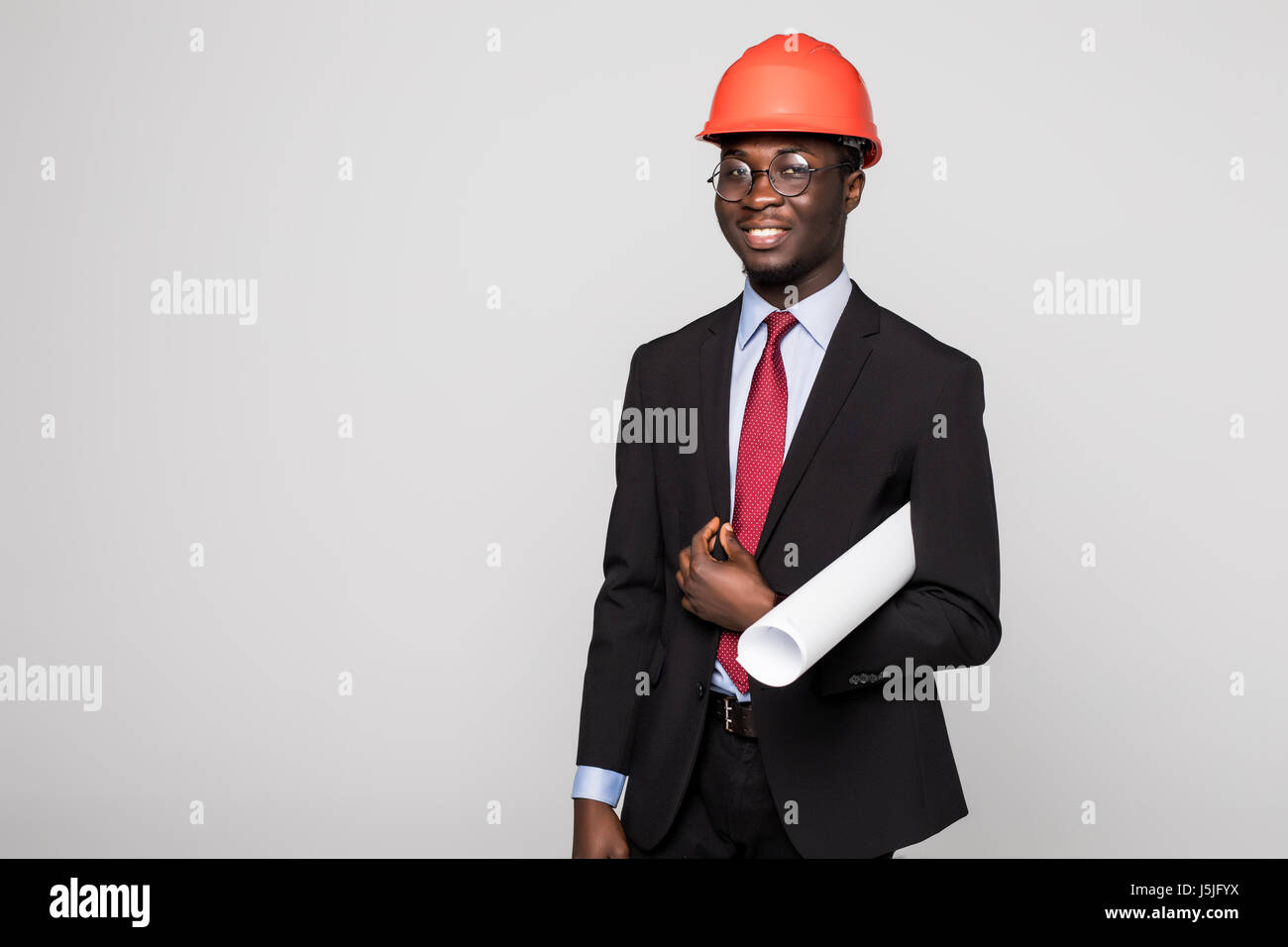 Young Afro-American engineer with blueprints isolated on white Stock ...