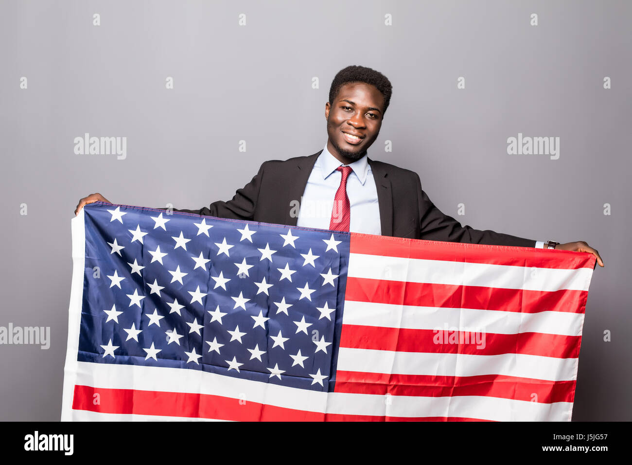 Handsome Afro American man in classic suit is smiling standing with ...