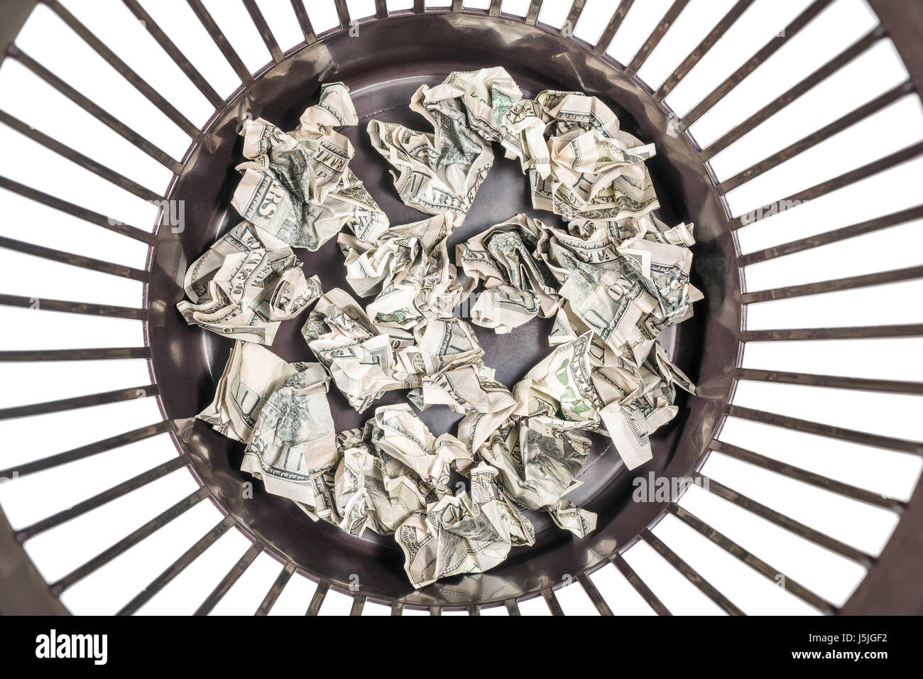 Crumpled hundred-dollar banknotes of money at the bottom of the trash ...