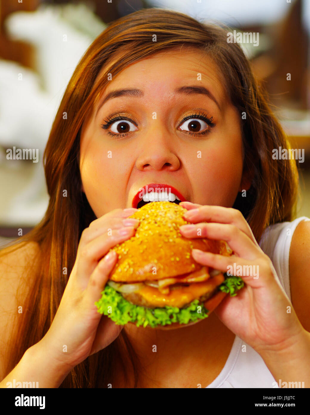 Close up of a beauty woman in cafe eating a delicious hamburger Stock ...