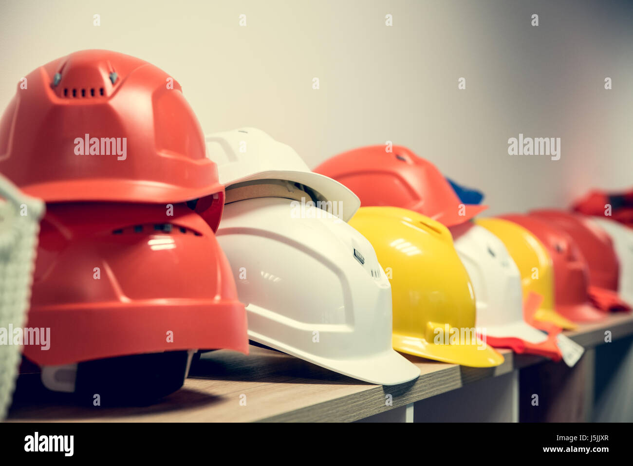 Group of safety helmets on the shelf in locker Stock Photo - Alamy