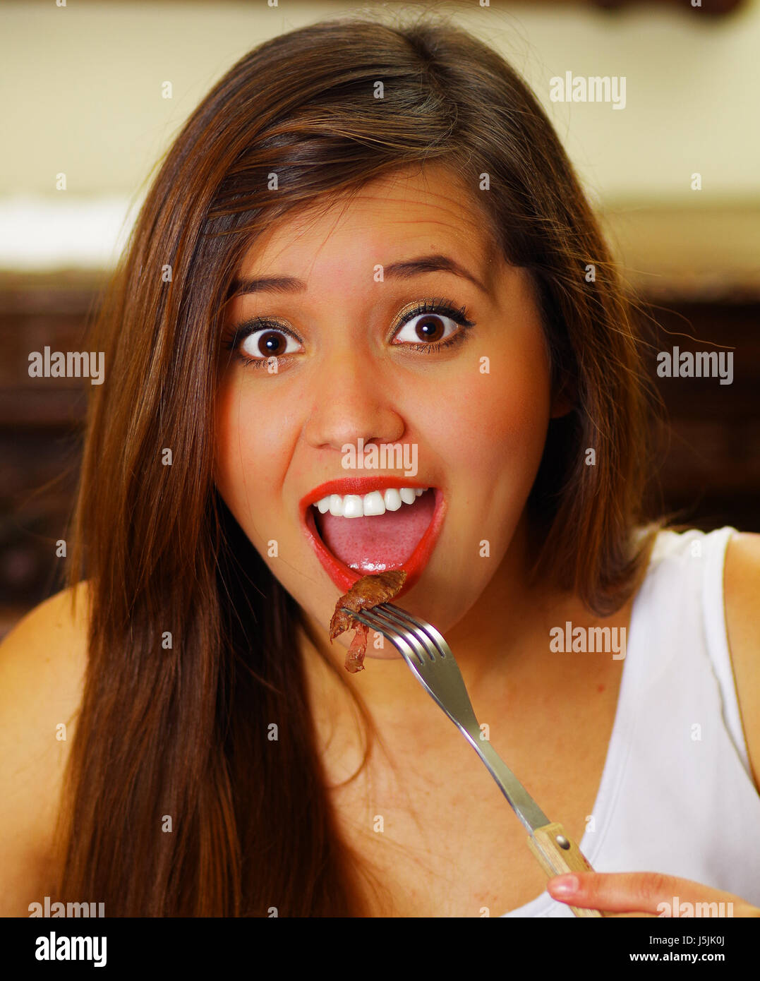 close up of a beauty woman in a restaurant eating a delicious meat ...
