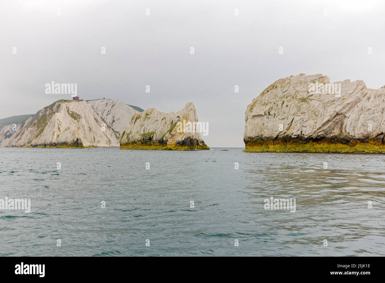 The Needles rock formation and chalk cliffs of High Down on the Isle of ...