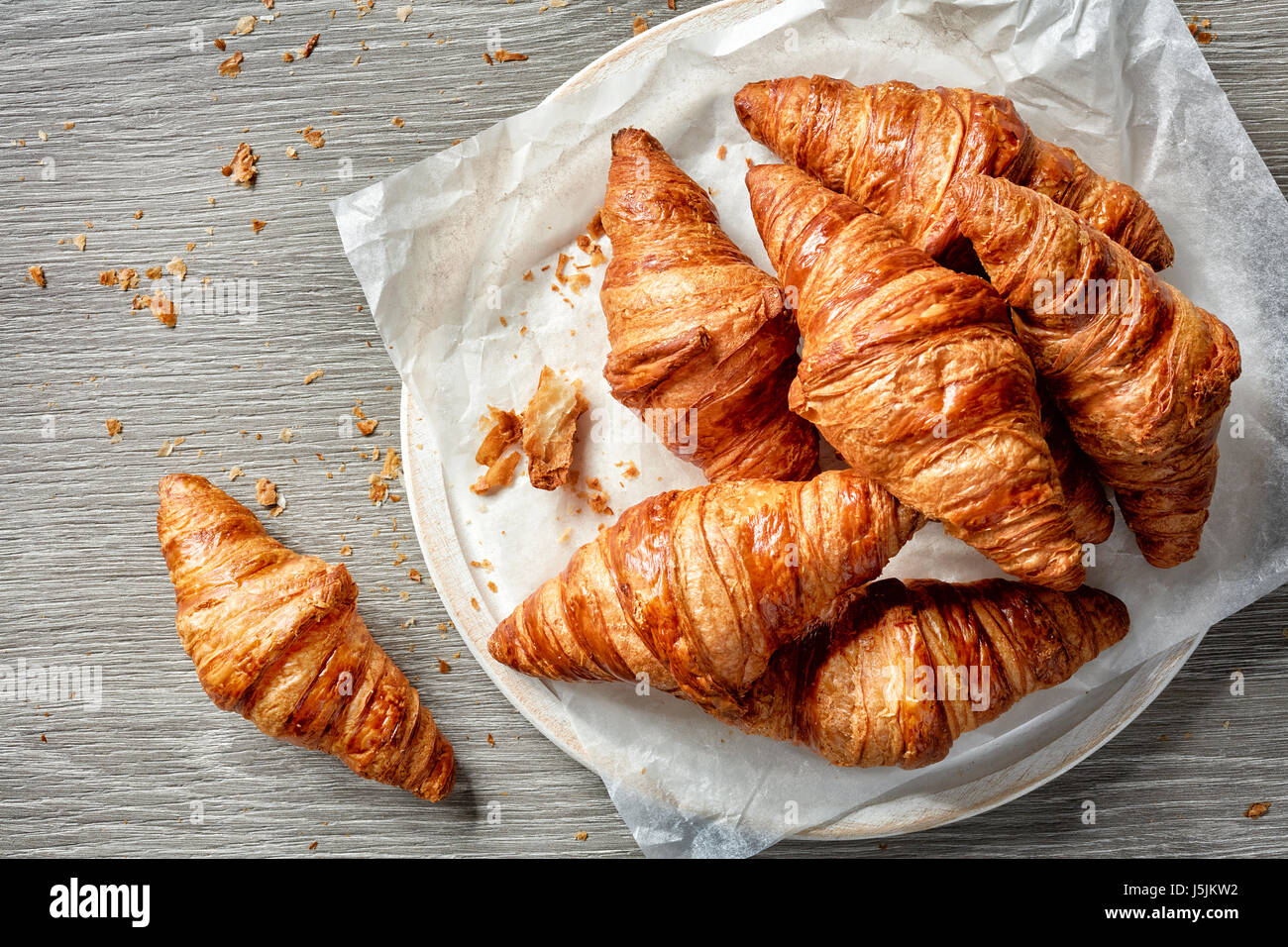 freshly baked croissants on grey wooden table, top view Stock Photo - Alamy