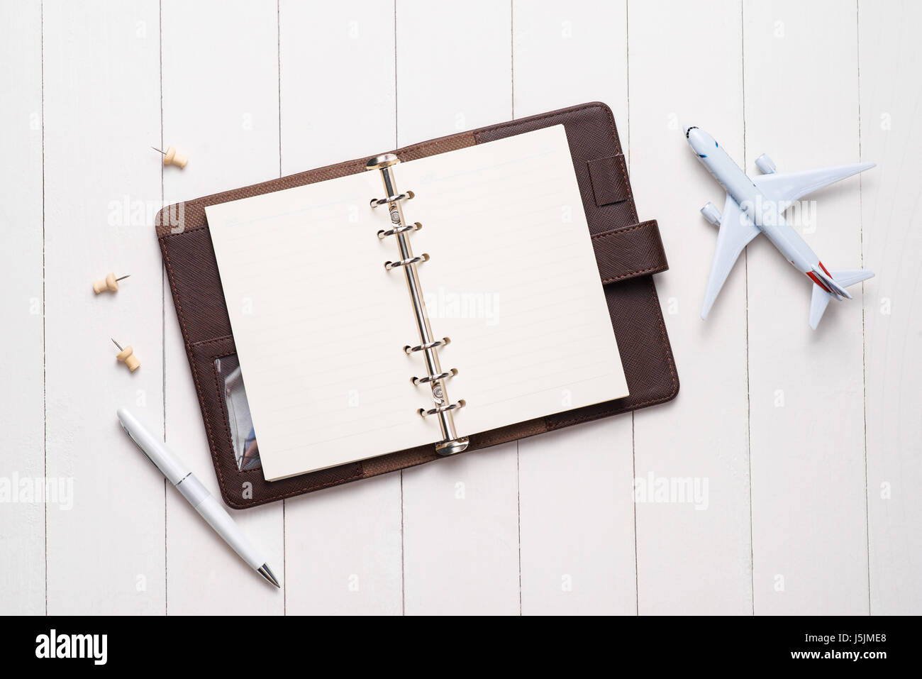 Business trip concept. Airplane and blank open notebook for your text ...