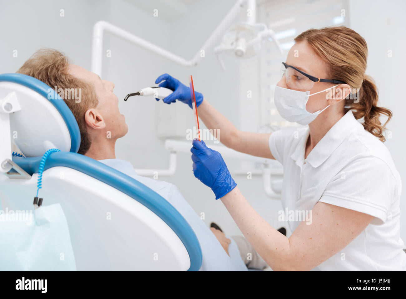 Trained precise expert conducting a procedure with special devices ...