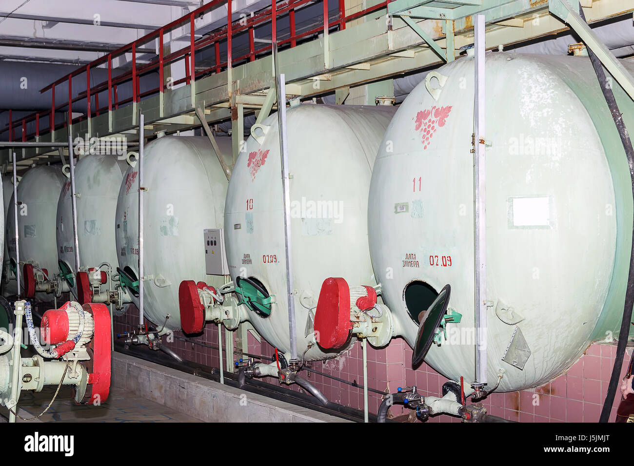Industrial Champagne wine storage, large cisterns in a huge dark vault ...