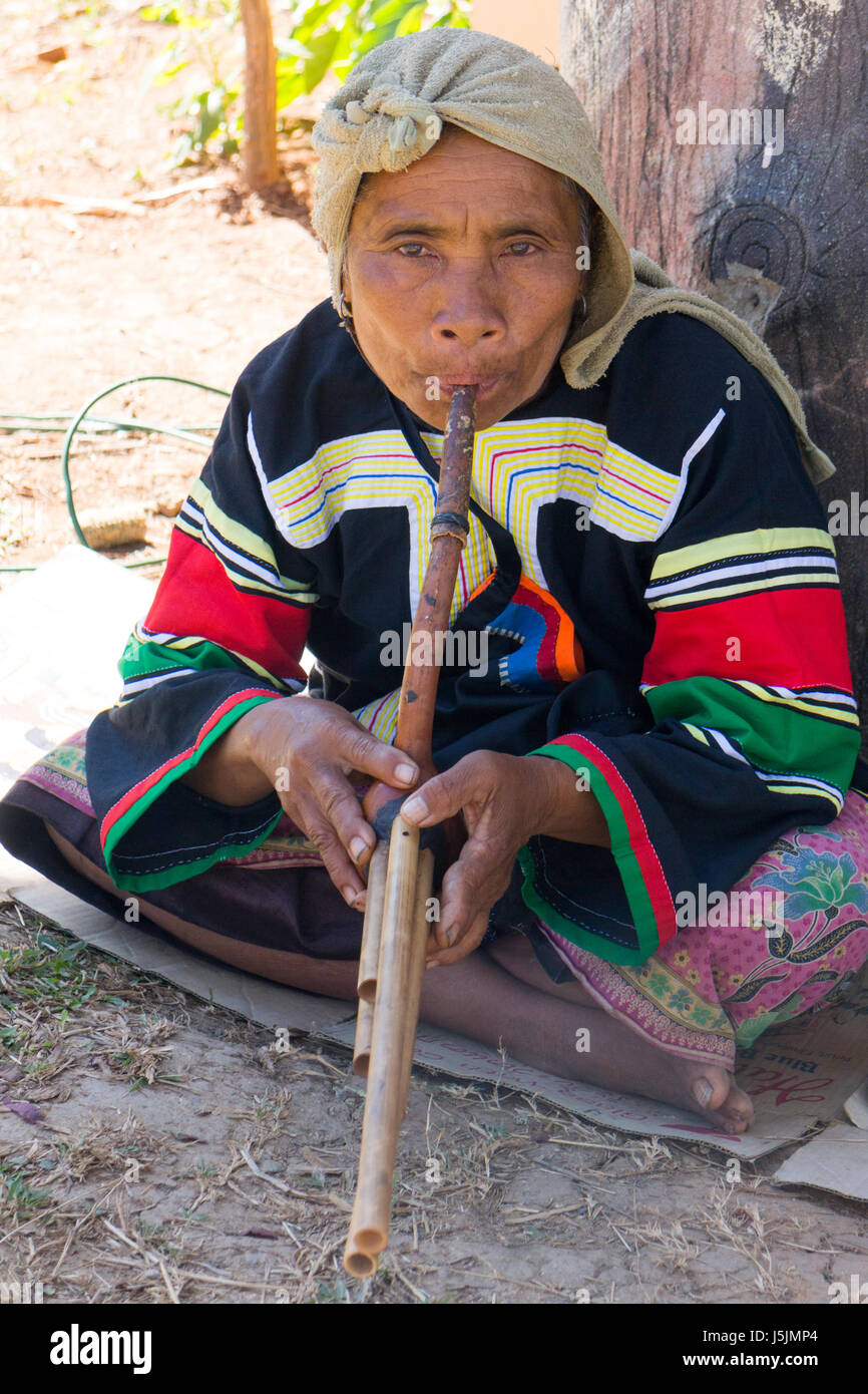 Lahu hilltribe woman playing a wind instrument in Chiang Rai province ...
