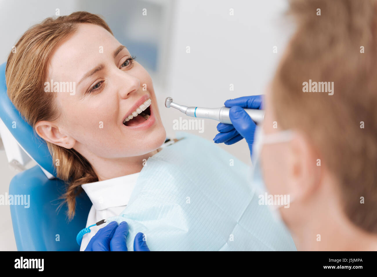 Elegant young woman having her teeth treated in clinic Stock Photo - Alamy