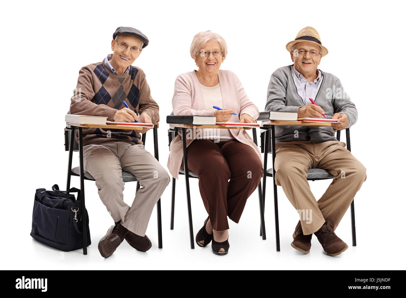 Seniors in school chairs taking notes and looking at the camera ...