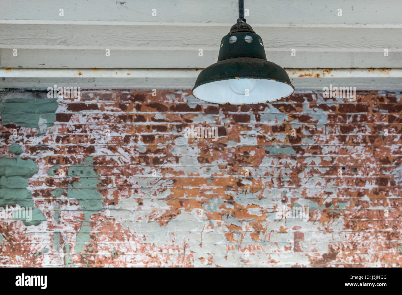 Rusted Old Black Lamp with Brick Wall Behind It Stock Photo - Alamy
