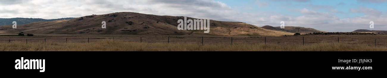 Panoramic View of Open Farm land with fence around it Stock Photo - Alamy