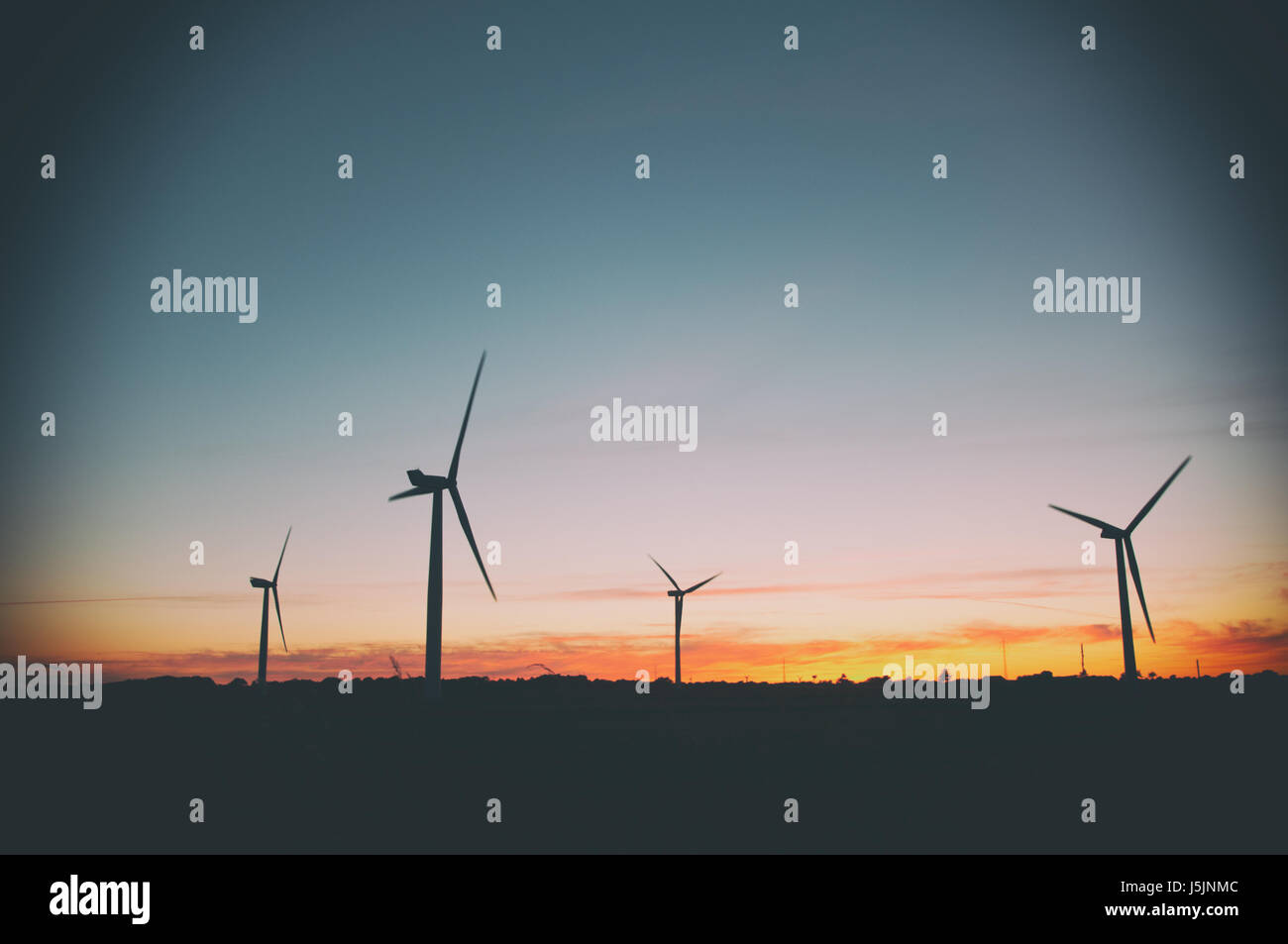 Wind turbines at sunset Stock Photo - Alamy
