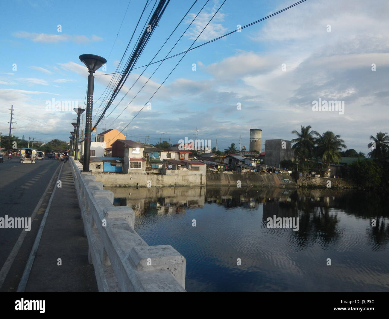 This photo captures a beautiful sunset scene over the Bocaue River ...