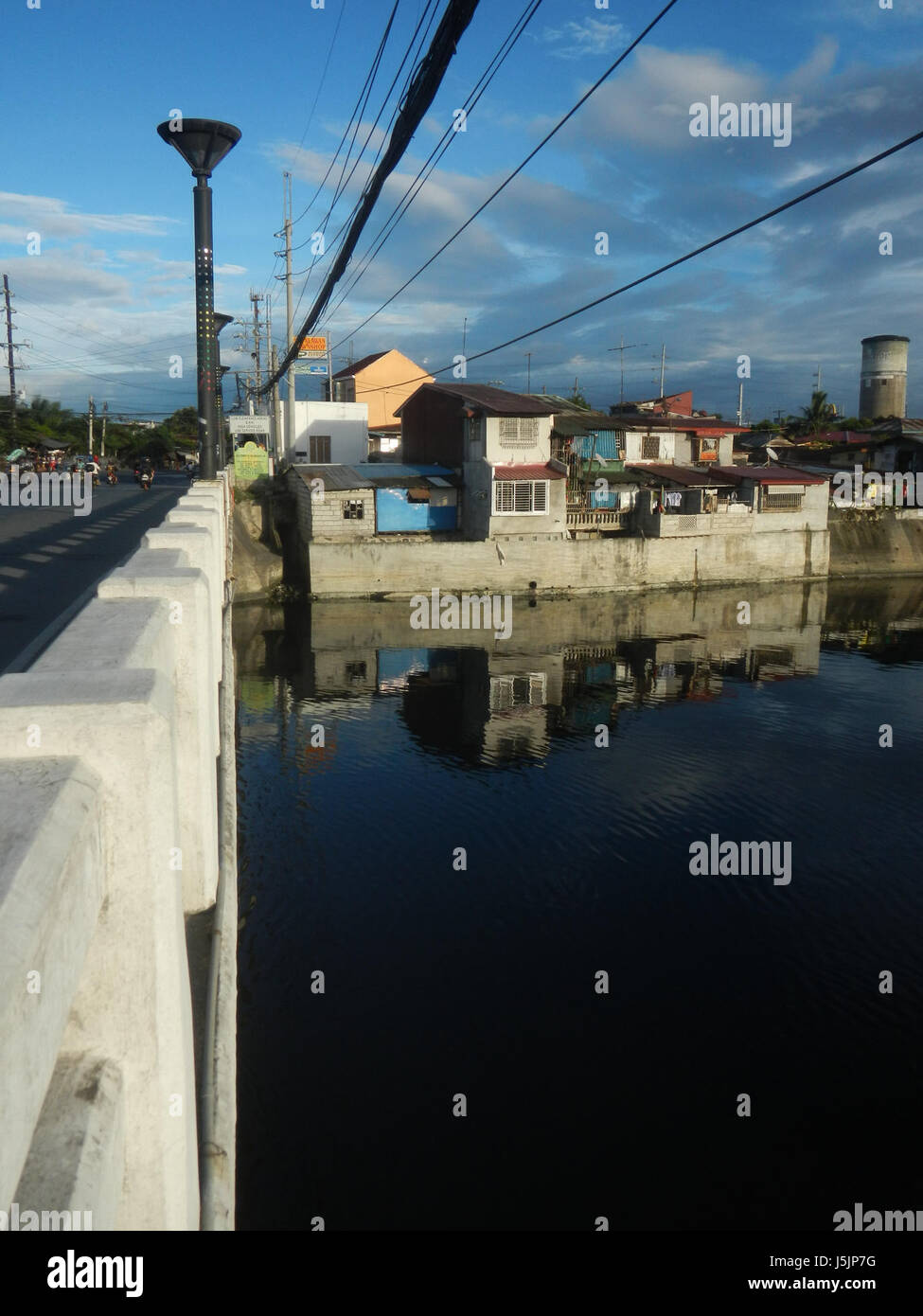 This image captures a scenic sunset view of the Bocaue River Bridge ...