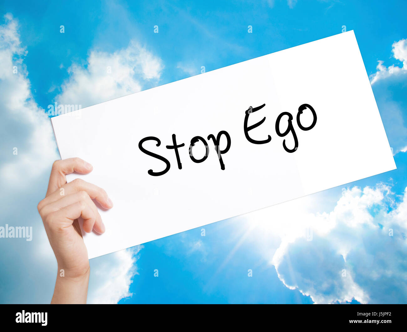 Stop Ego Sign on white paper. Man Hand Holding Paper with text ...