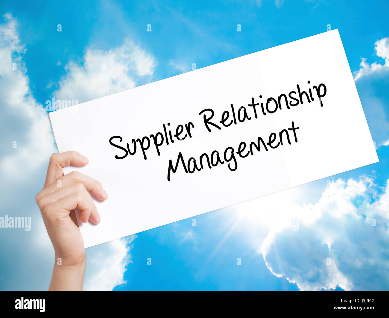 Supplier Relationship Management Sign on white paper. Man Hand Holding ...