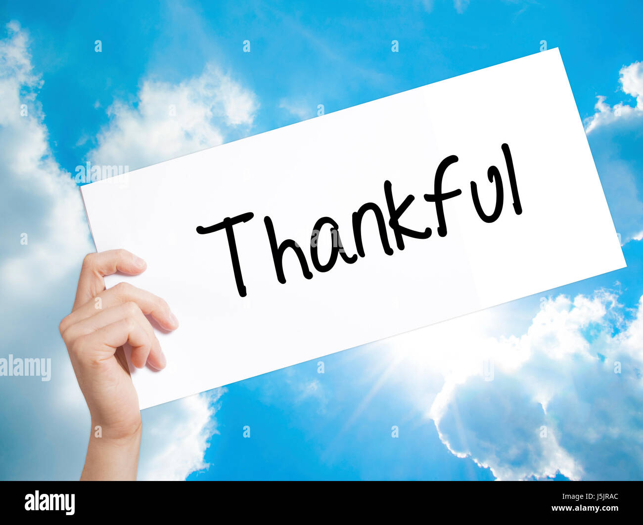 Thankful Sign on white paper. Man Hand Holding Paper with text ...
