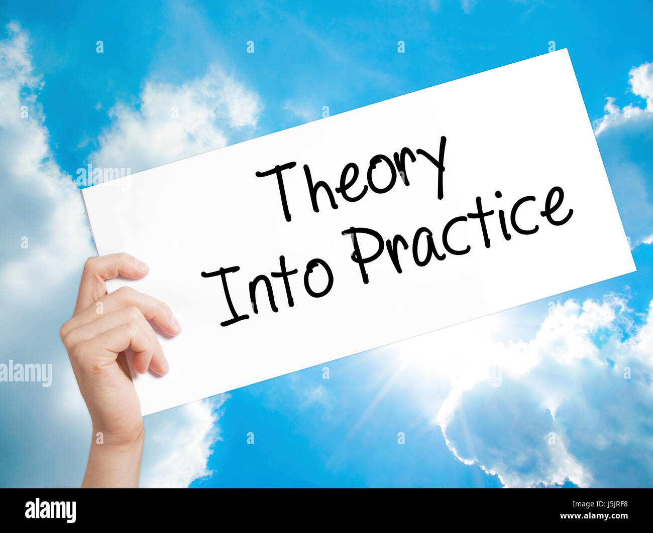 Theory Into Practice Sign on white paper. Man Hand Holding Paper with ...