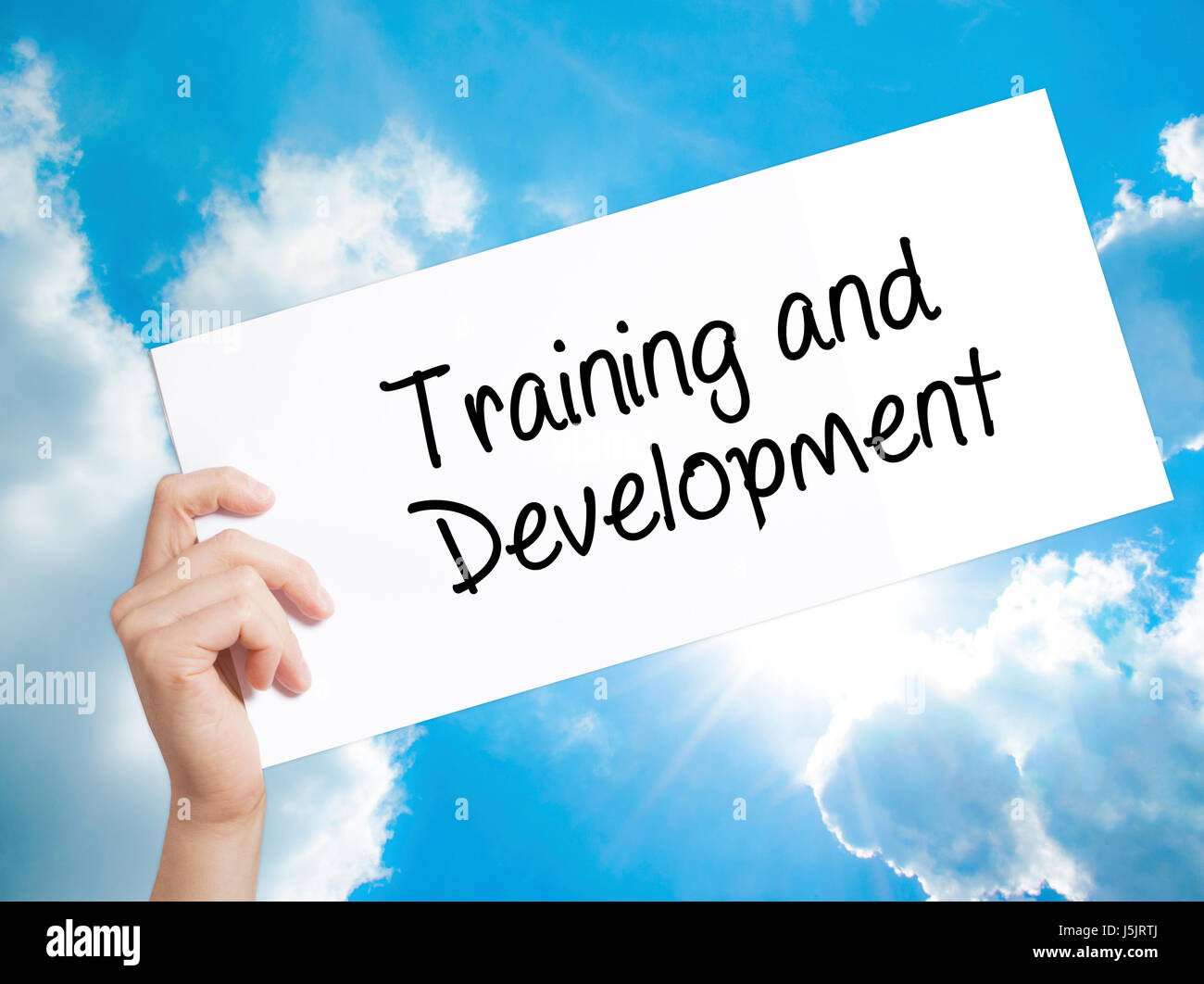 Training and Development Sign on white paper. Man Hand Holding Paper ...