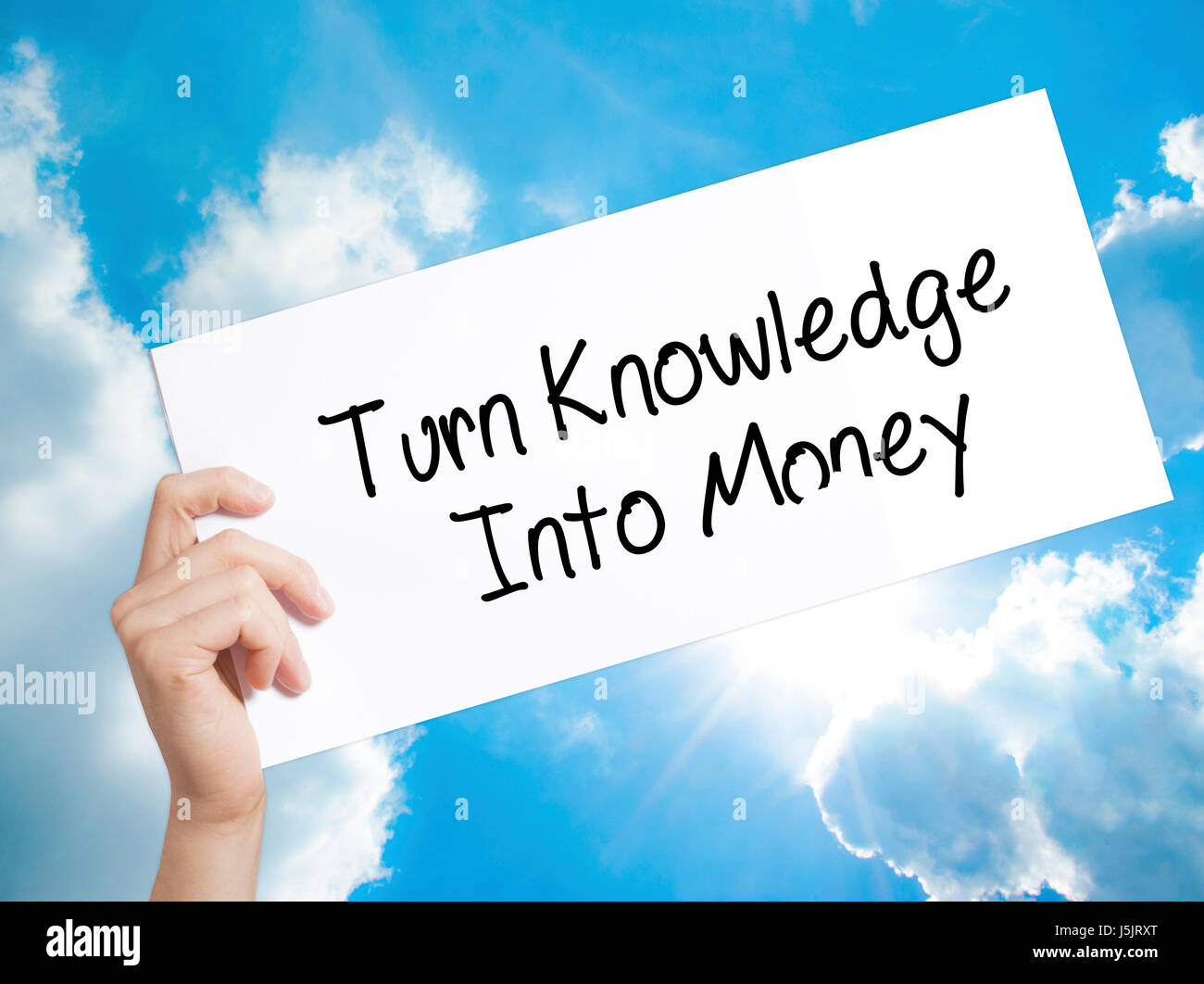Turn Knowledge Into Money Sign on white paper. Man Hand Holding Paper ...