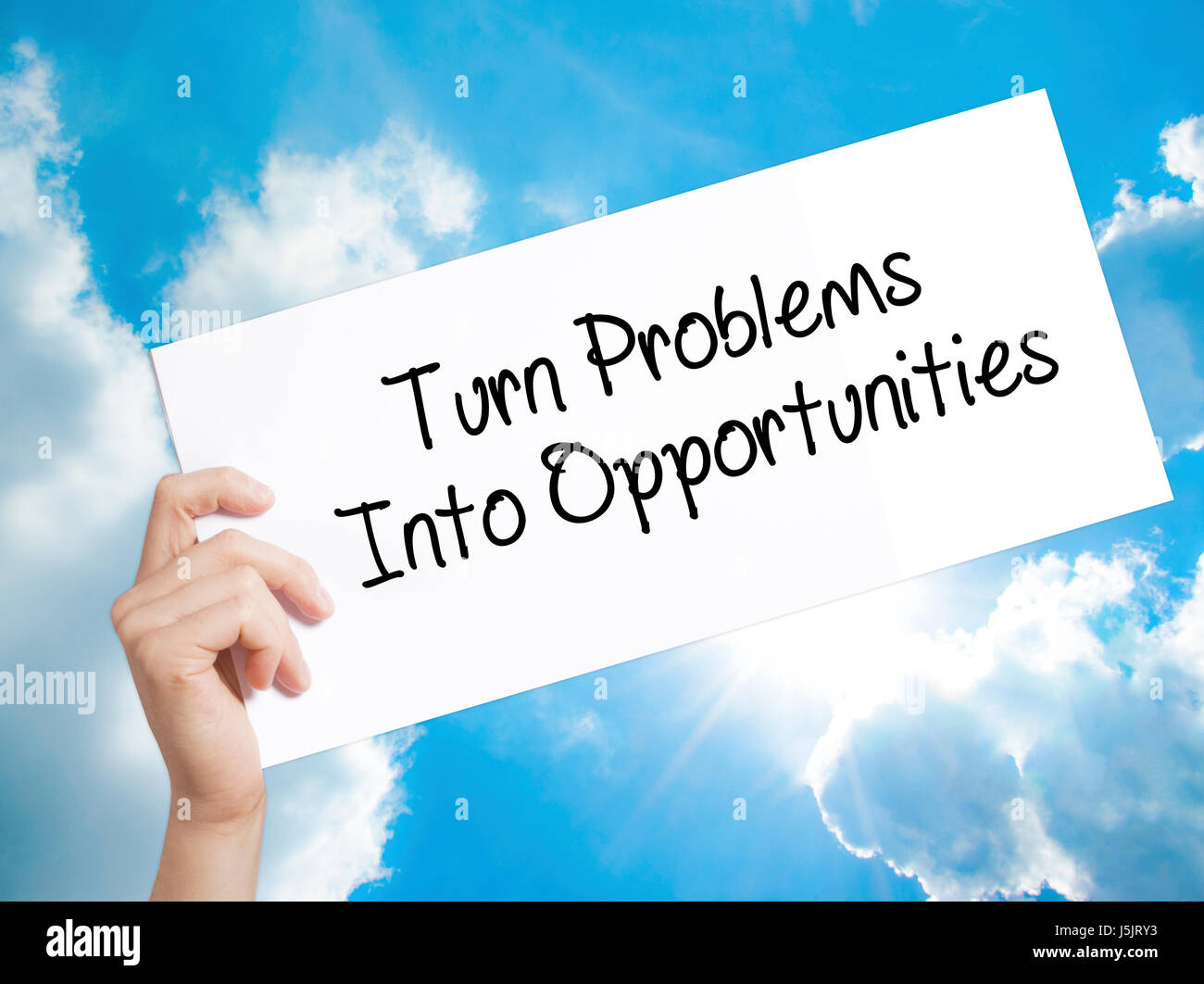Turn Problems into Opportunities Sign on white paper. Man Hand Holding ...