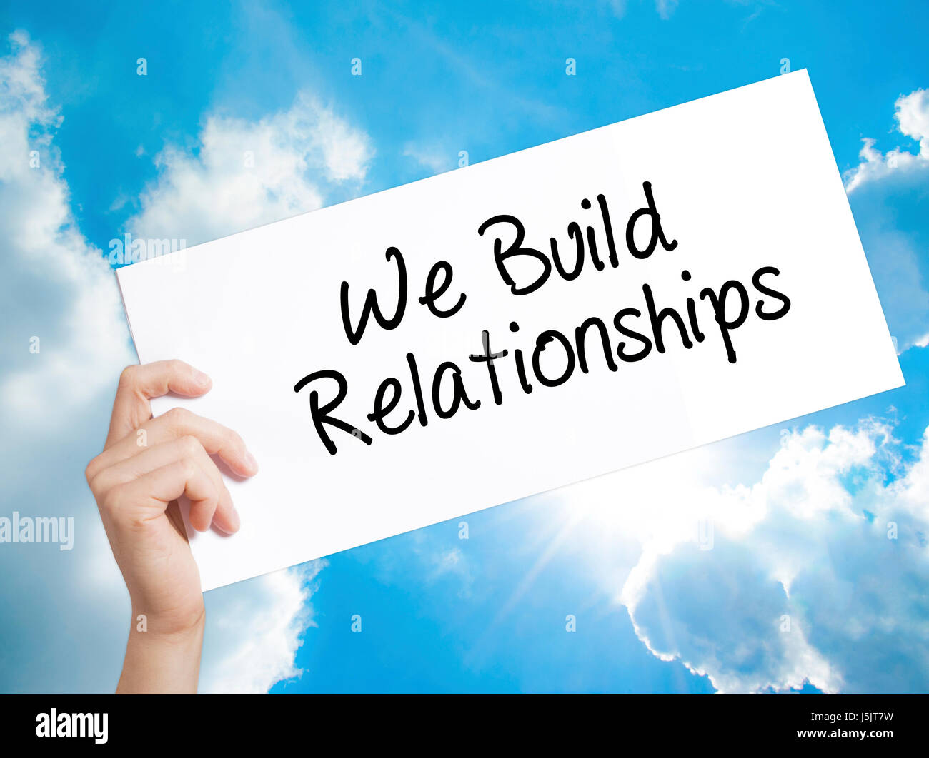 We Build Relationships Sign on white paper. Man Hand Holding Paper with ...