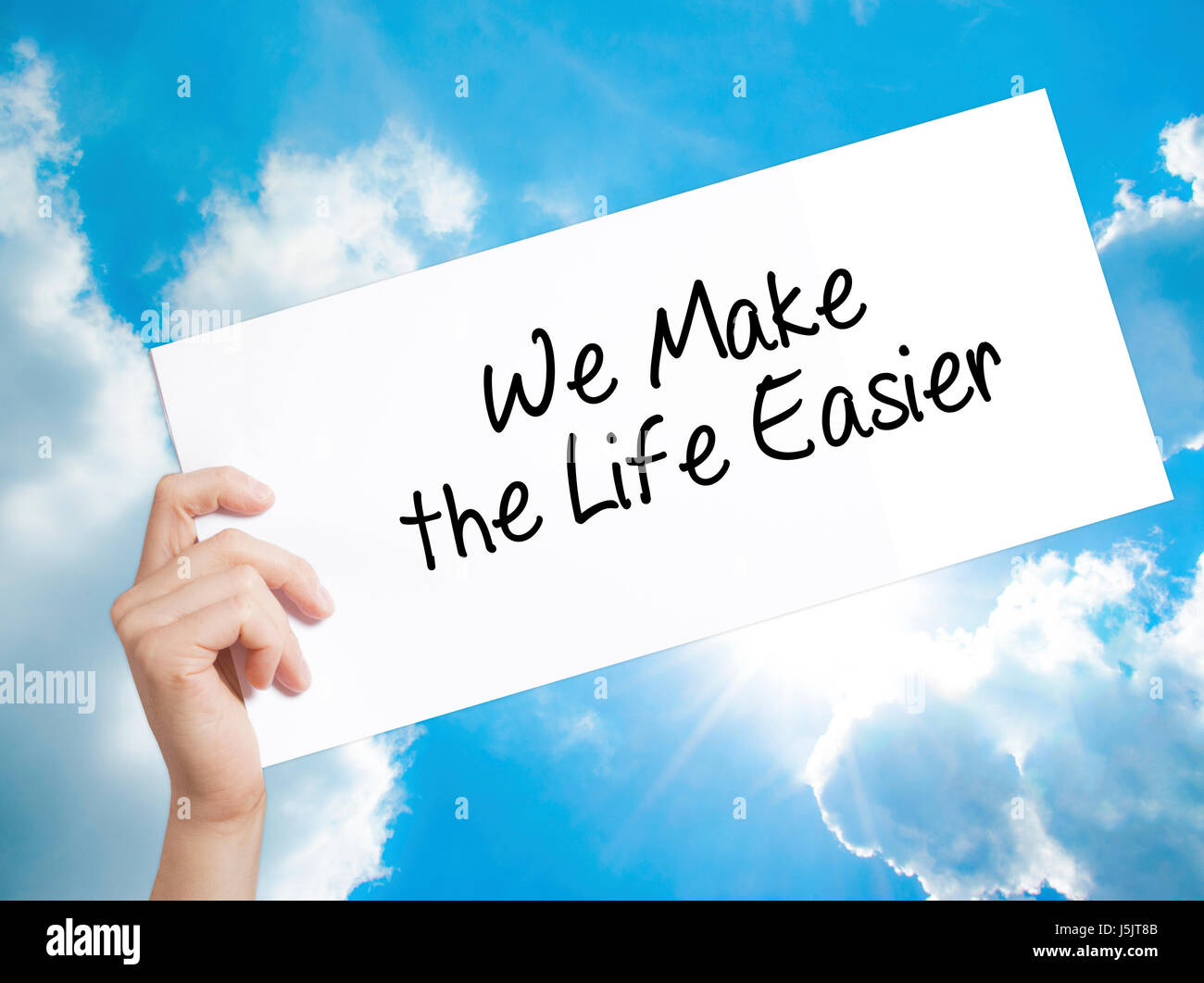 We Make the Life Easier Sign on white paper. Man Hand Holding Paper ...