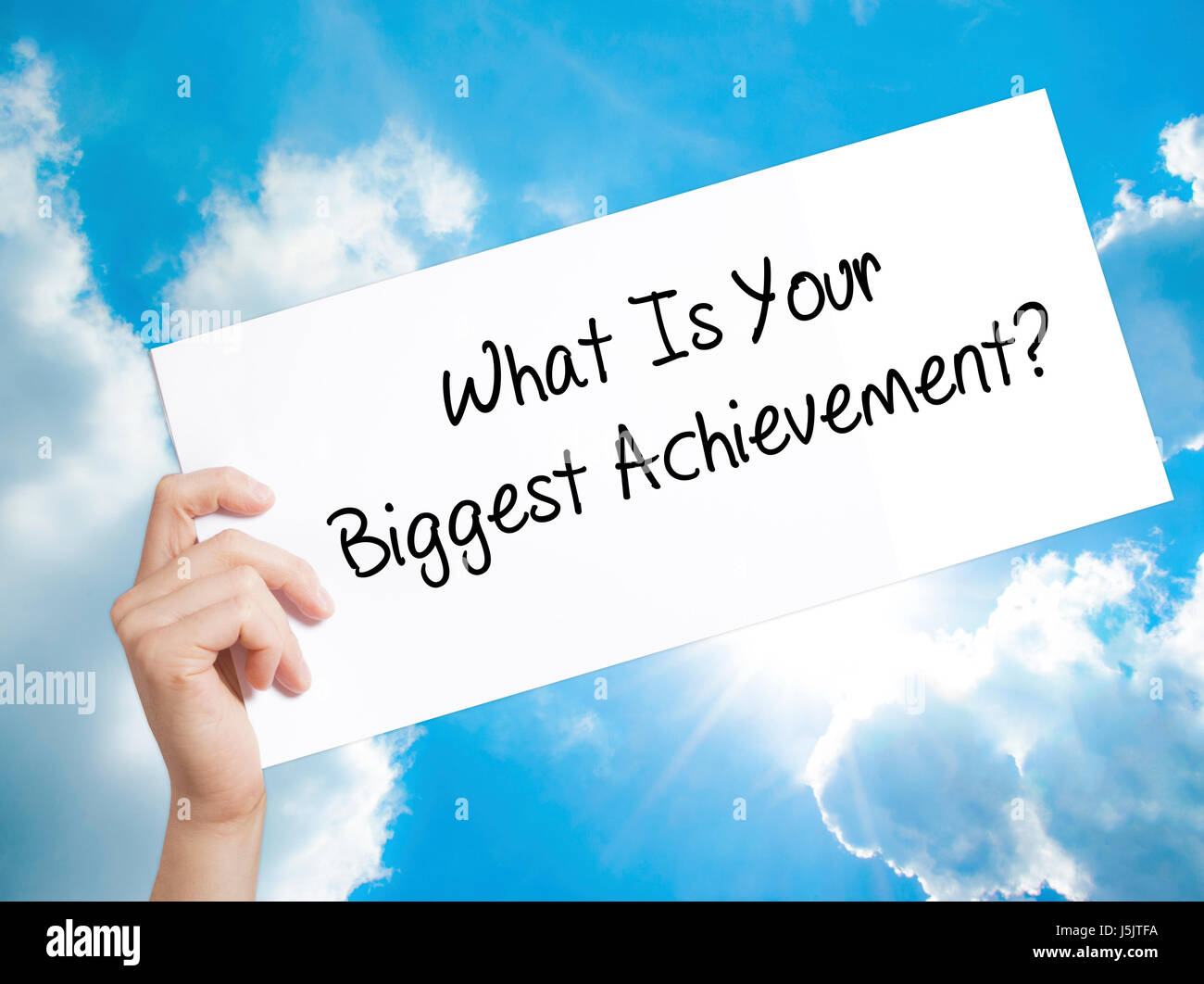 What Is Your Biggest Achievement? Sign on white paper. Man Hand Holding ...