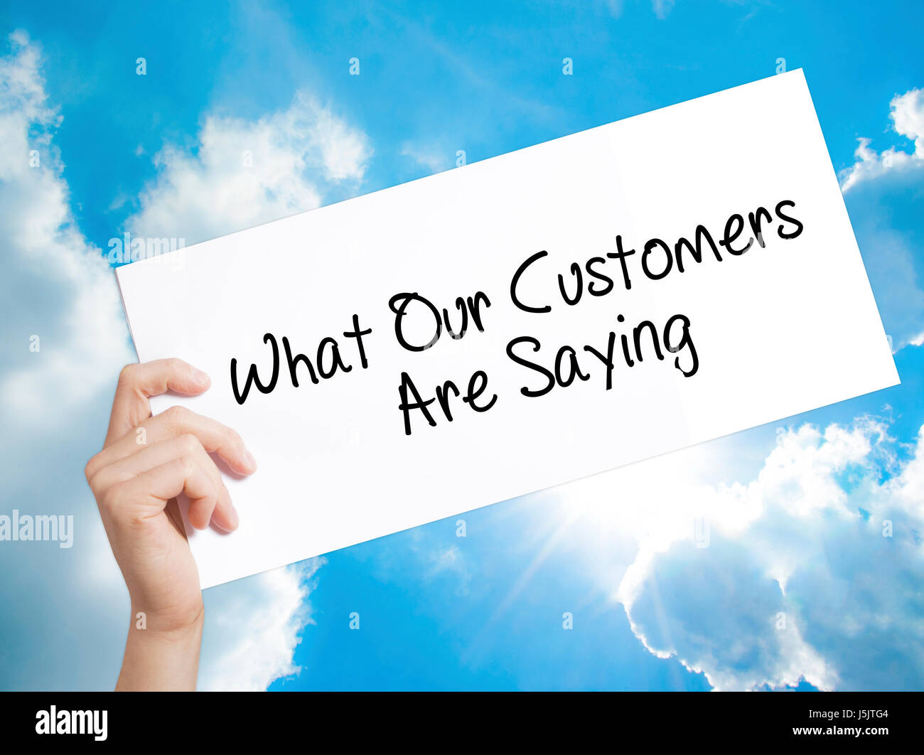 What Our Customers Are Saying Sign on white paper. Man Hand Holding ...