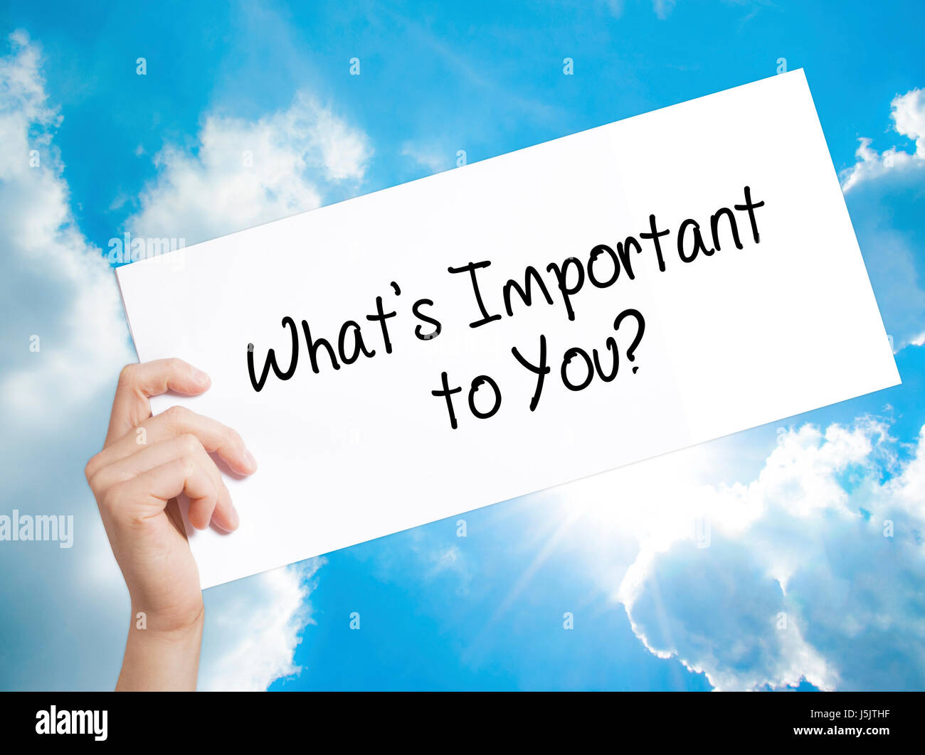 What's Important to You? Sign on white paper. Man Hand Holding Paper ...