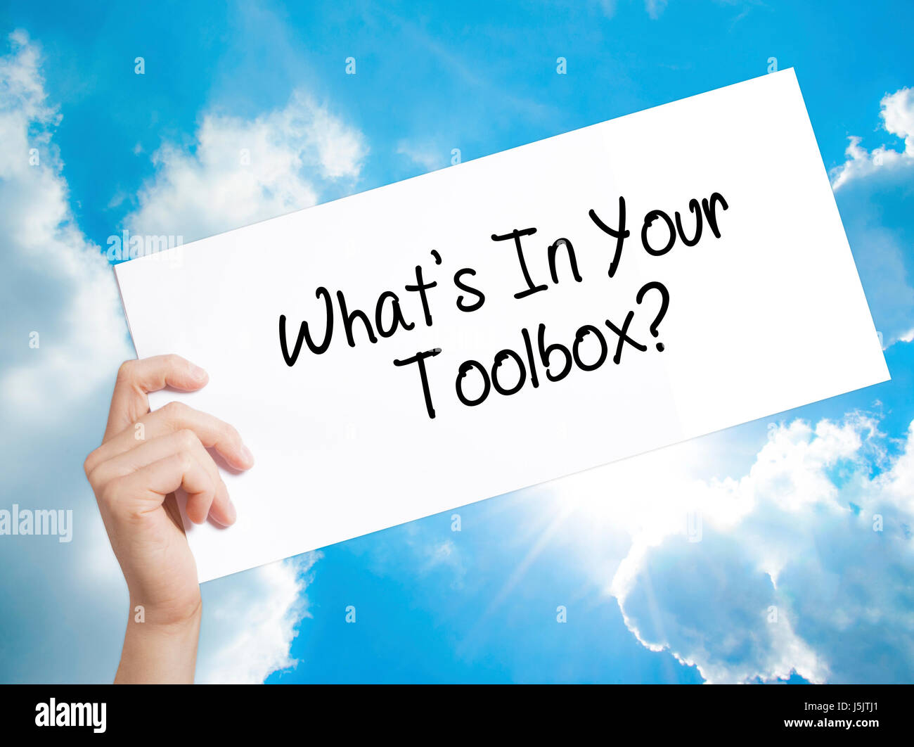 What's In Your Toolbox? Sign on white paper. Man Hand Holding Paper ...