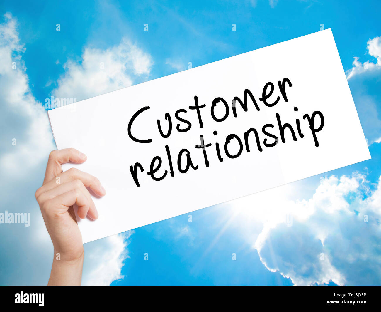 Customer relationship Sign on white paper. Man Hand Holding Paper with ...