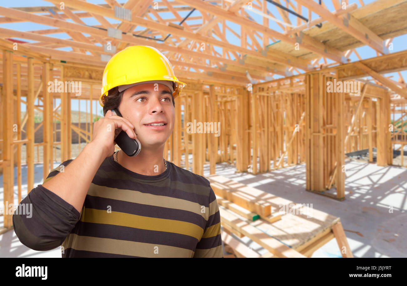 Hispanic Contractor Using Phone On Site Inside New Home Construction ...